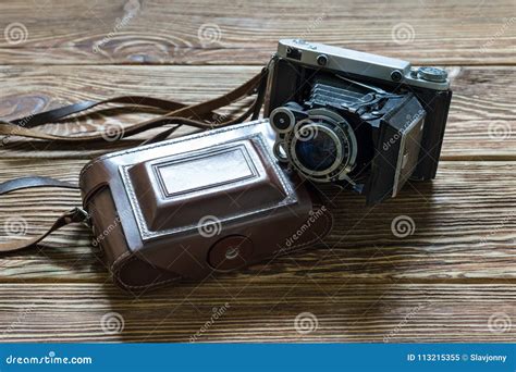 The Old Medium Format Rangefinder Camera And Leather Case Wooden