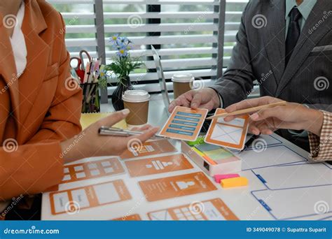 Ux Developer And Ui Designer Presenting Mobile App Interface Design On Whiteboard In Meeting At