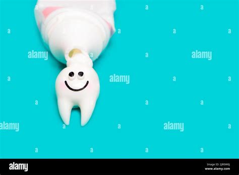 Funny Tooth Character Enjoys Toothpaste Application Isolated On Blue