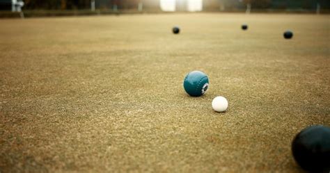 Premium Photo Green Balls And Game Of Lawn Bowling On Grass Field Or