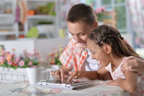 Portrait Of Brother And Babe Using Tablet Stock Photo Image Of Education Emotions 305347700