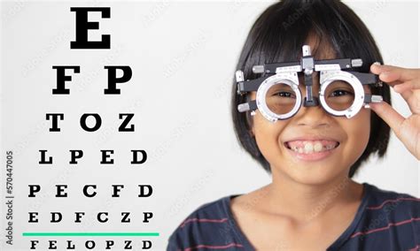 Elementary School Girl Wearing Eyeglasses Visual Acuity Test With Test