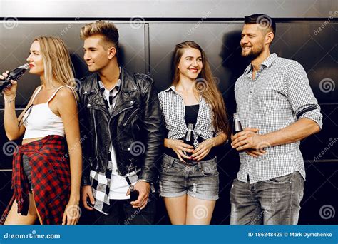 Group Of Young Stylish Friends Girls And Guys Posing Together Against