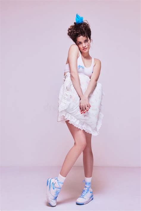 Tender And Elegant Young Woman With Stylish Hairstyle And Head Feather