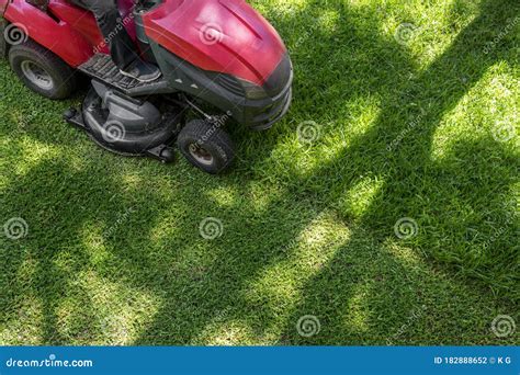 Top Down Above View Of Professional Lawn Mower Worker Cutting Fresh Green Grass With Landcaping