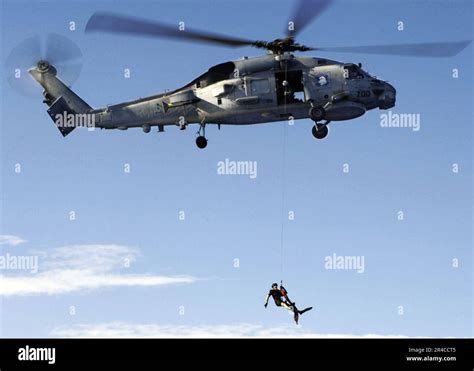 Us Navy An Sh 60b Seahawk Helicopter Assigned To Hsl 47 Lowers A Rescue