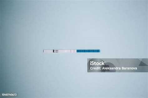 Positive Pregnancy Test With Two Strips And Pink Hearts Blue Background