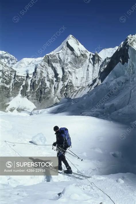 Crossing A Crevasse On Mount Everest In The Khumbu Icefall Superstock