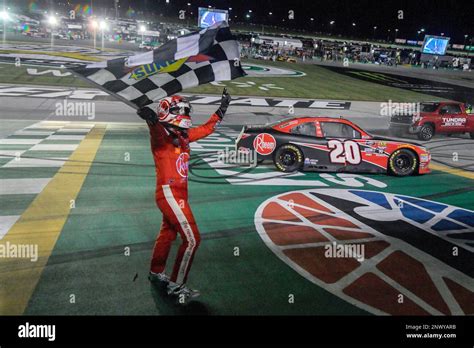 christopher bell 20 collects the checkered flag after the nascar