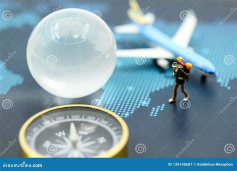Miniature People Backpackers Traveler Standing With Compass On The