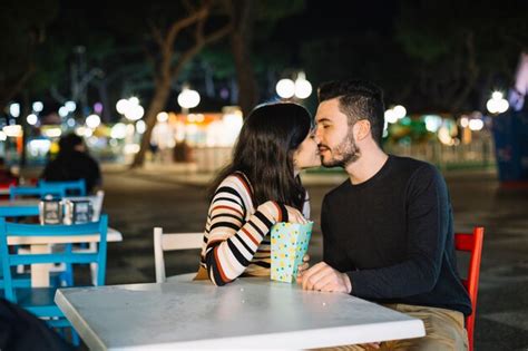 Pareja Besándose En El Parque De Atracciones Foto Gratis