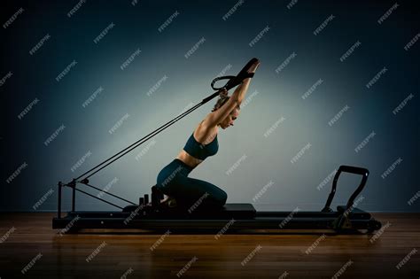 Young Girl Doing Pilates Exercises With A Reformer Bed Beautiful Slim