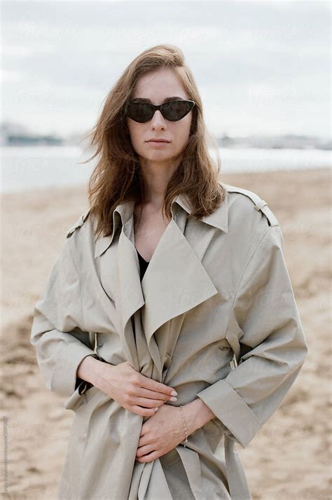 Portrait Of Young Woman Wearing Trench Coat And Sunglasses By Stocksy