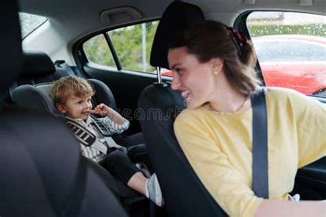 Mother Checking Her Son Before Ride In Car Stock Image Image Of