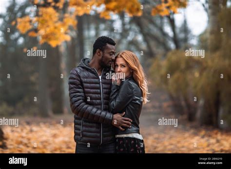 Interracial Couple Posing In Blurry Autumn Park Background Black Man