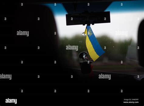 A Ukranian Flag With The Coat Of Arms Tryzub Trident On It Hangs From A Tourist Van At The