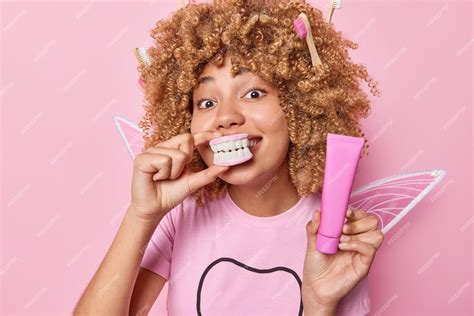 Premium Photo Happy Sweet Tooth Holds Sweet Candy And Toothpaste