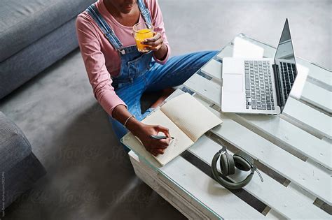 Woman Writing Notes At Her Coffee Table By Stocksy Contributor Ivan Gener Stocksy