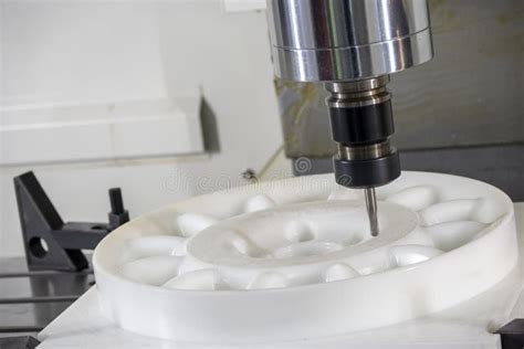 The CNC Milling Machine Cutting The Nylon 6 Material Part With Ball End Mill Tool Stock Image