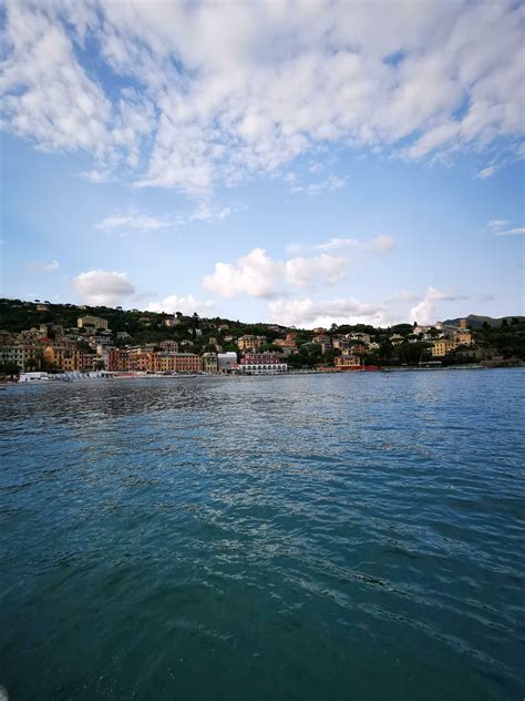 Photo Of A Scenic View Of Houses On A Hill Overlooking A Beautiful Body