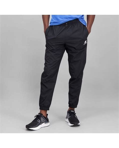 New Balance Nb Athletics Higher Learning Wind Trousers In Blue For Men