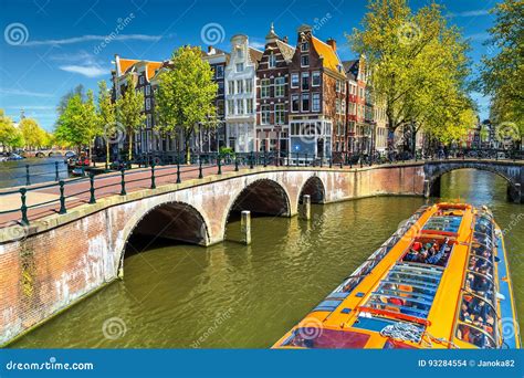 Typical Amsterdam Canals With Bridges And Colorful Boat Netherlands