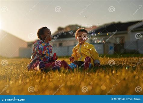 Playing Better With Bubbles Shot Of A Brother And Sister Sitting On