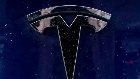 Download Tesla Logo An Iconic Symbol Of Innovation Wallpaper
