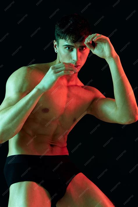 Premium Photo Sexy Male Bodybuilder Gestures With His Hands On A