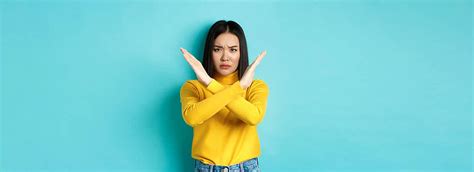 Assertive Korean Woman Stops And Disapproves Over Blue Background Photo And Picture For Free