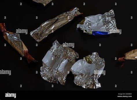 Random Blank Candy Wrappers On A Black Table Multicolored Foil