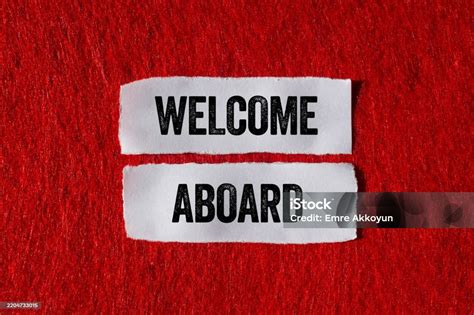 Welcome Aboard Message Written On Ripped Torn Paper Pieces On Red