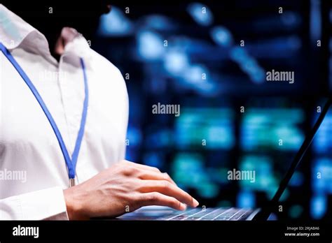 Specialist Using Laptop To Do Troubleshooting On Data Center Mainframes