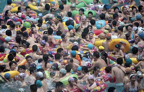 Thousands Of People Pack Swimming Pools And Beaches In China To Escape