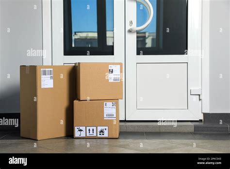 Cardboard Boxes On Floor Near Entrance Parcel Delivery Service Stock