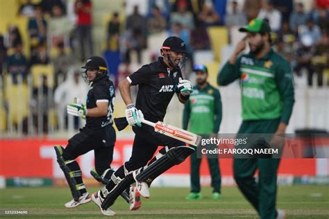 New Zealand's Daryl Mitchell and Tom Latham run between the wickets ...
