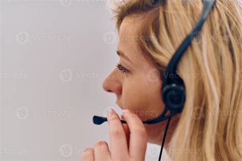 Friendly Call Center Agent Answering Incoming Calls With Headset