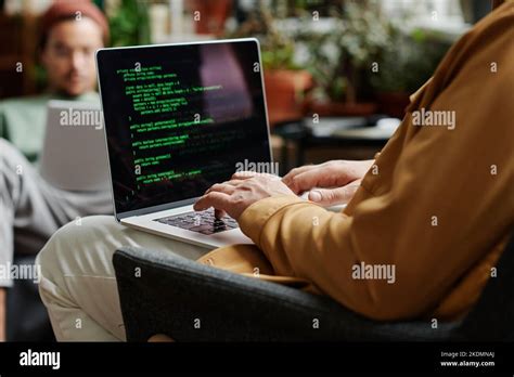 Mature Professional It Engineer Developing New Software Or Decoding Data On Laptop Scren While