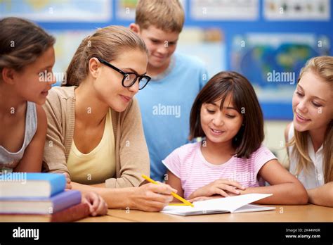 Sharing Her Love Of Learning A Teacher Helping Her Students With Their