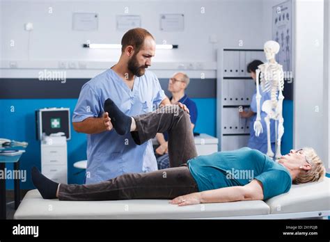 Physiotherapist Stretching Leg Muscle To Relieve Pressure For Recovery