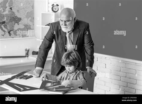 Elementary School Elementary School Teacher Giving Female Pupil Support In Classroom Stock