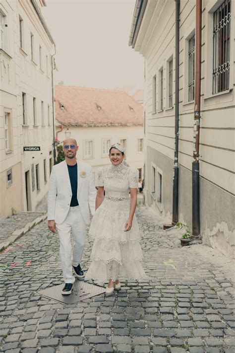 Groom In Light Linen Casual Outfit And Bride In Layered Tulle Dress