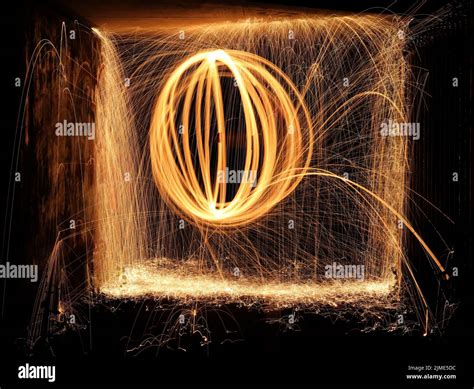 Steel Wool Spinning In A Tunnel Throwing Off Yellow And Orange Sparks