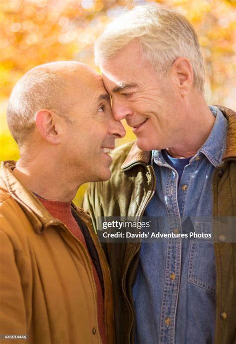 Mature Gay Male Couple Affectionately Looking At Each Other And