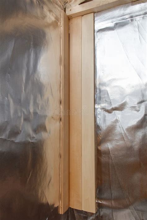 A Wooden Beam Is Visible In The Corner Of A Room With A Silver Sheet