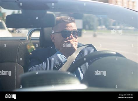 Shocked Driver In The Car A Businessman Driving A Car Covers His Mouth With His Hand An