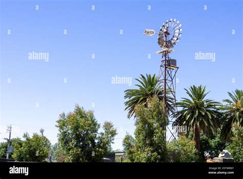 The Iconic Metal Windmill Used To Pump Underground Water Into Elevated Holding Tanks For Water