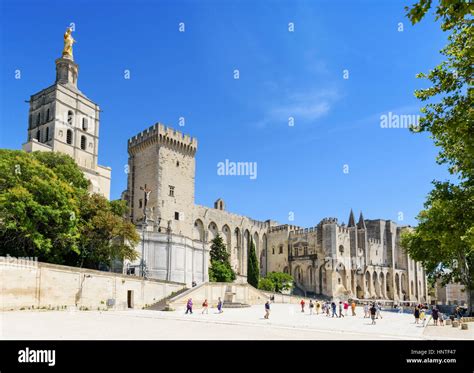 People In Palace Square Overlooked By Avignon Cathedral And The Palace