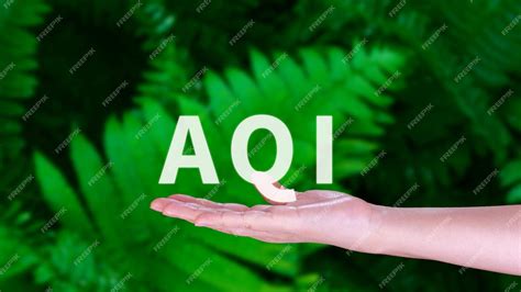 Premium Photo Aqi Abbreviation Of Air Quality Index Hand Holding Aqi On Nature Background