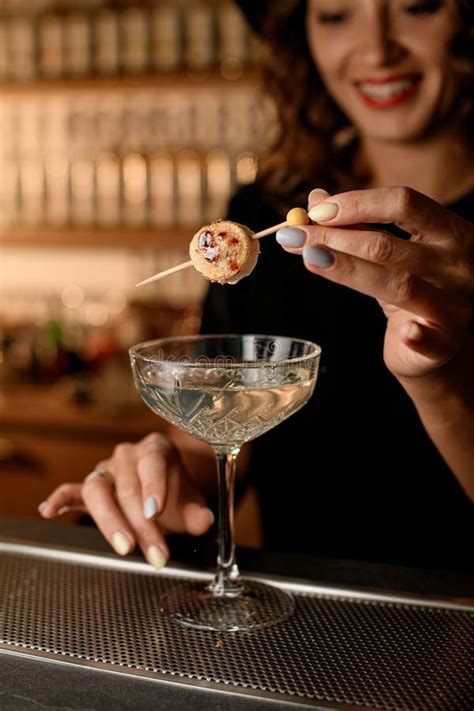 Cute Smiling Female Bartender Holding Skewer With Banana And Fried